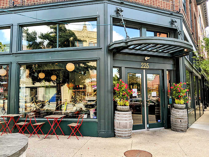 Ellie's charming corner storefront beckons with its forest green facade and rustic wine barrels. Providence architecture at its most inviting!