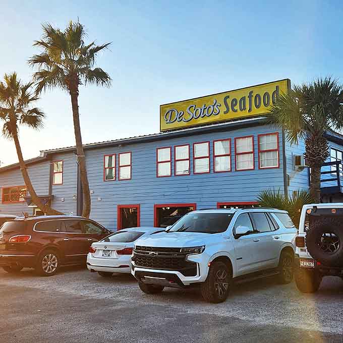 As the sun begins to set, De Soto's distinctive yellow sign promises an authentic Gulf Shores seafood experience worth remembering.