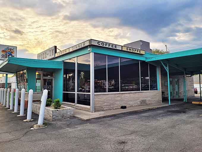 The Steer-In's iconic turquoise trim and vintage signage stand out against the Indiana sky, like a mid-century postcard come to life.