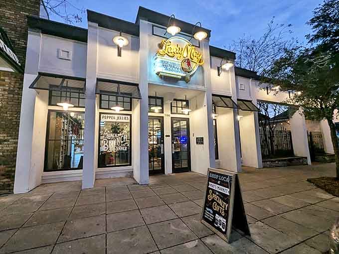 The Lady May's illuminated storefront beckons like a lighthouse for hungry souls wandering through Ocean Springs after dark. Pure coastal charm with urban sensibility.