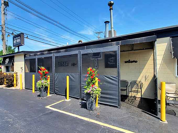 The Cozy Grill's outdoor seating area, complete with weather protection and colorful planters, offers additional space for hungry patrons awaiting those legendary home fries.