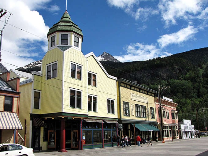 Skagway's colorful Victorian architecture stands proudly against the dramatic mountain backdrop, like a movie set where nature decided to outshine the production designer.