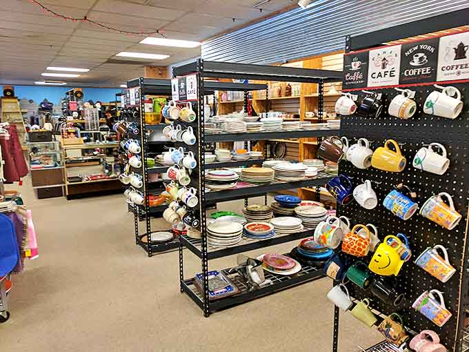 Colorful mugs hang alongside neatly organized dishware in Restyle's kitchen section, where vintage and modern pieces create a treasure hunter's paradise.