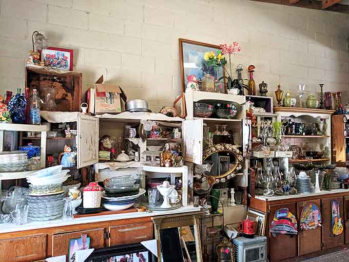Treasure hunter's paradise! Shelves overflow with vintage glassware, collectibles, and nostalgic knickknacks waiting to find new homes at The Barnyard.