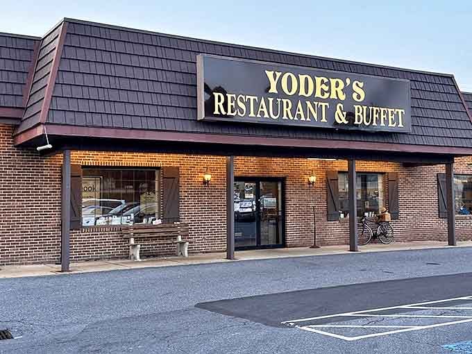 With its exterior lights glowing, Yoder&rsquo;s shifts from a busy lunch spot into an inviting dinner destination. The shingled roof and brick exterior hide culinary magic within.