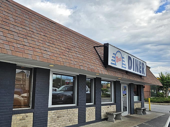 The unassuming brick exterior of Marie's Diner stands like a beacon of breakfast hope along La Plata's roadside, promising comfort food salvation within.