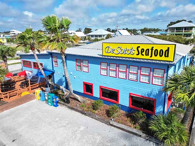 The unmistakable bright blue exterior of De Soto's Seafood Kitchen stands out like a delicious mirage among the palm trees of Gulf Shores.