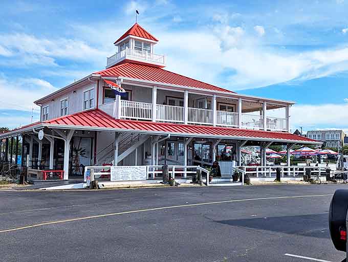 The iconic red-roofed Wheelhouse stands like a maritime lighthouse for hungry souls, promising seafood treasures within its distinctive coastal architecture.