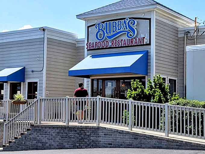 Bubba's iconic blue sign welcomes seafood lovers like a lighthouse guiding hungry sailors home. The white railing practically begs you to climb those steps to crab cake paradise.