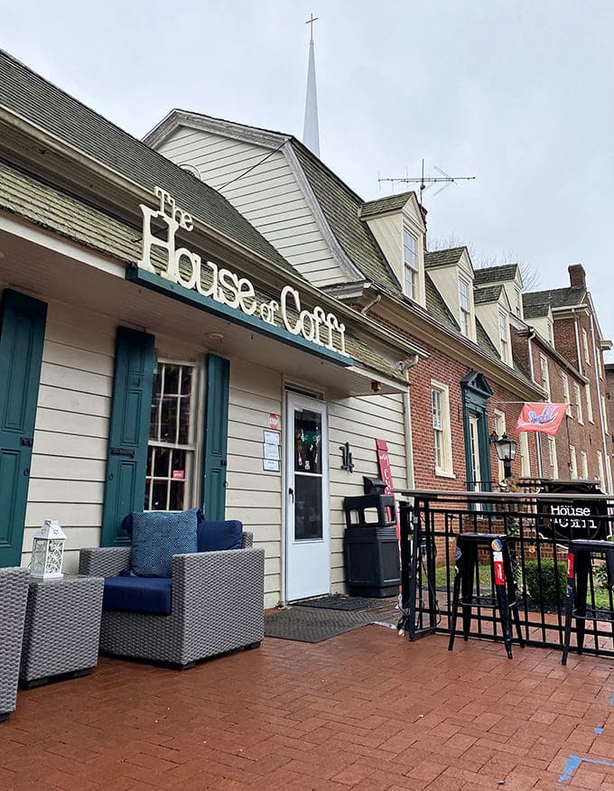 The charming exterior of House of Coffi beckons with its cream siding and brick pathway&mdash;like a coffee oasis in downtown Dover.