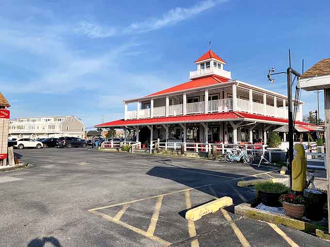 The iconic red-roofed Wheelhouse stands like a maritime lighthouse for hungry souls, promising seafood treasures within its distinctive coastal architecture.
