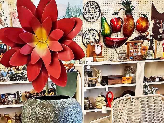 A vibrant metal flower blooms eternally among colorful fruit sculptures and curio-filled shelves &ndash; proof that yesterday's decor can still make tomorrow's statement piece.