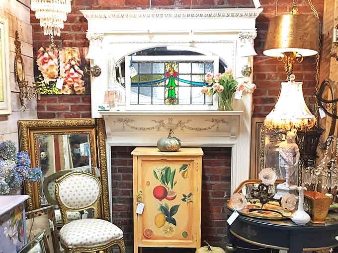 That stained glass window above the vintage mantle isn't just decoration&mdash;it's a portal to another era. Elegant lighting fixtures and painted furniture create a vignette of timeless charm.