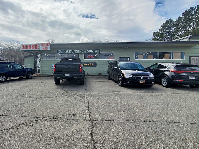 The welcoming facade of Central Maine Antique Mall, where vintage treasures await behind this unassuming green exterior.