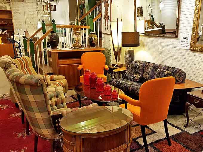 Mid-century modern meets vintage comfort in this retro living room display. Those orange chairs aren't just seating&mdash;they're time machines to cocktail parties past.