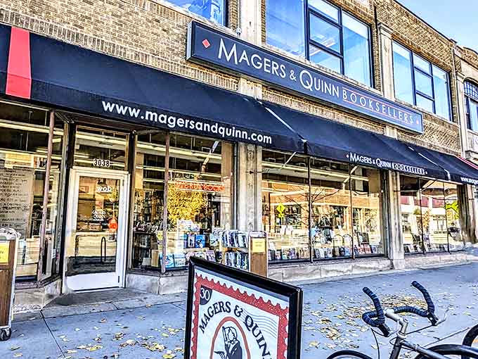 The iconic navy blue awning of Magers & Quinn stands as a literary lighthouse on Hennepin Avenue, beckoning bibliophiles into its paper paradise.