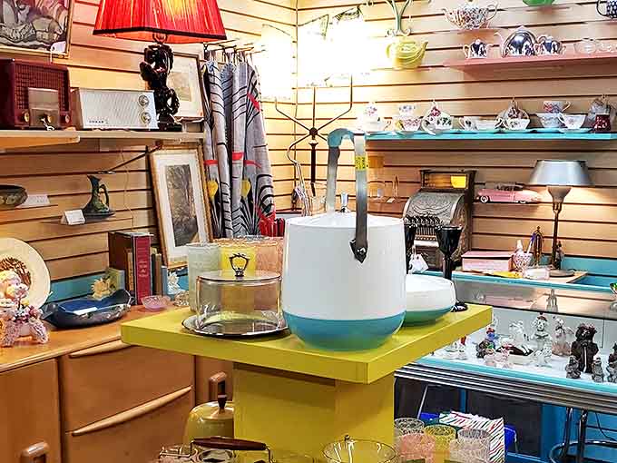 Mid-century modern meets vintage kitsch in this carefully curated booth. That turquoise pitcher? Your grandmother probably served lemonade in its twin.