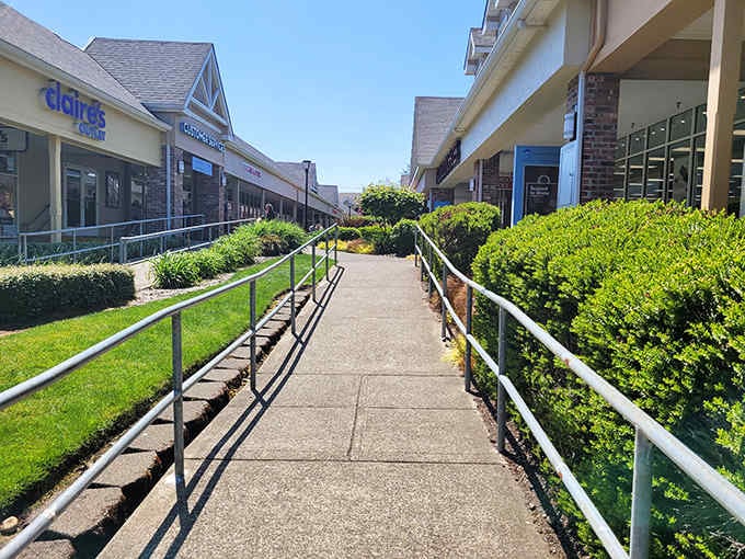 Perfectly manicured walkways guide shoppers between storefronts, where coastal charm meets retail therapy in this open-air bargain paradise.