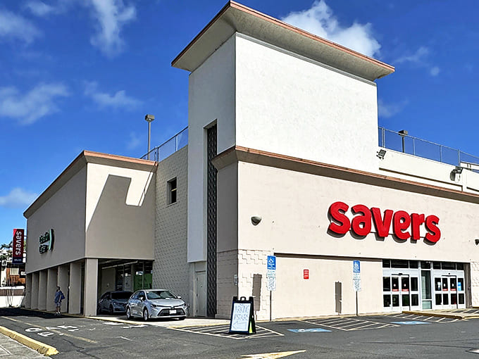 The white fortress of frugality stands proudly under Hawaiian skies, its red Savers sign a beacon to bargain hunters across Honolulu.