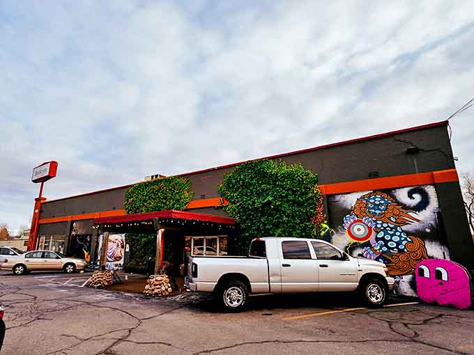 The exterior of Restyle beckons with its vibrant mural and distinctive orange trim &ndash; a visual promise that ordinary thrifting ends where Boise's treasure hunting begins.