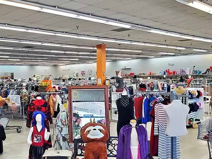 A treasure hunter's paradise where clothing racks stretch to the horizon. That stuffed sloth seems to be saying, "Take your time, the best finds require patience."