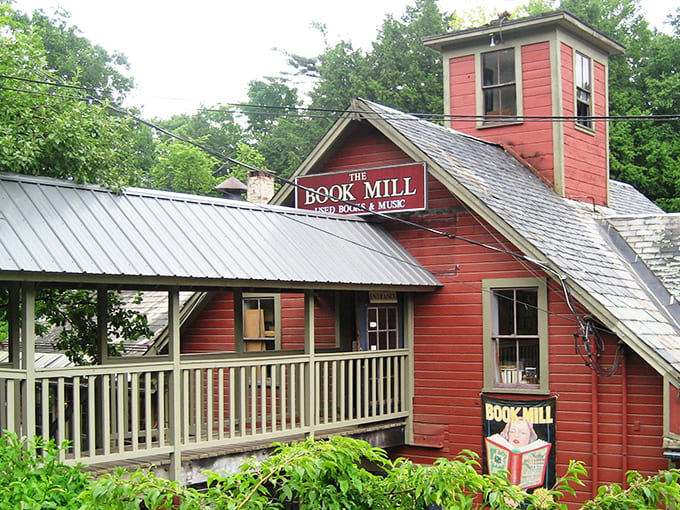 The iconic red clapboard exterior of the Montague Bookmill stands like a literary lighthouse, beckoning bibliophiles to its "Books you don't need in a place you can't find."