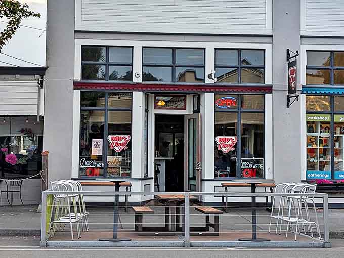 The unassuming storefront of Dad's Diner beckons with its simple red neon "OPEN" sign&mdash;like a lighthouse guiding hungry sailors to breakfast salvation.