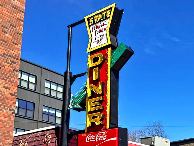 That iconic vertical sign isn't just advertising &ndash; it's a beacon of hope for the hungry, promising "finest foods" and delivering on that promise since day one.