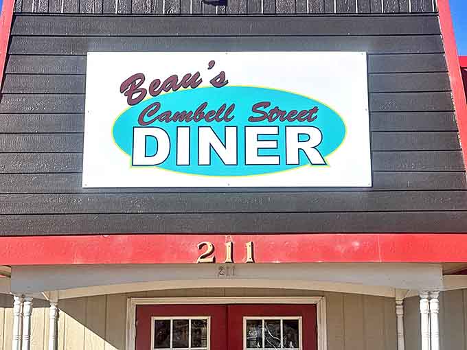 The bright turquoise sign against the red-roofed building is like a beacon for breakfast lovers. Beau's Cambell Street Diner promises comfort before you even step inside.