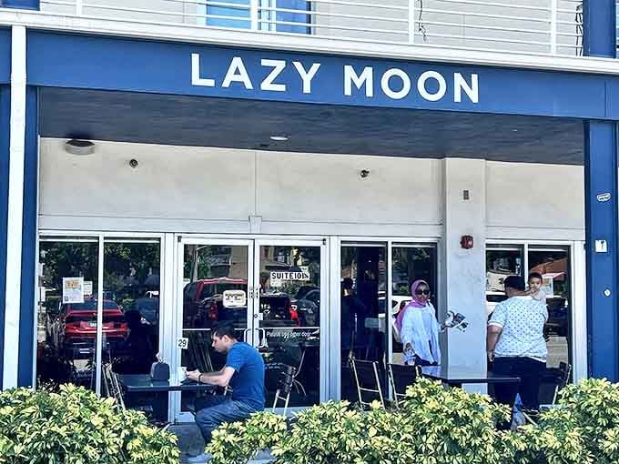 Sunlight bounces off Lazy Moon's welcoming exterior, where the promise of enormous pizza slices awaits just beyond those glass doors.