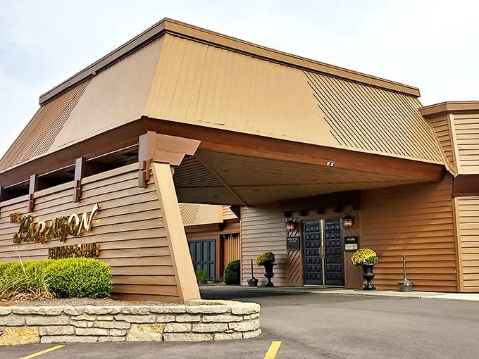 Heavy wooden doors flanked by manicured shrubs&mdash;this isn't just an entrance, it's a portal to the golden age of dining.