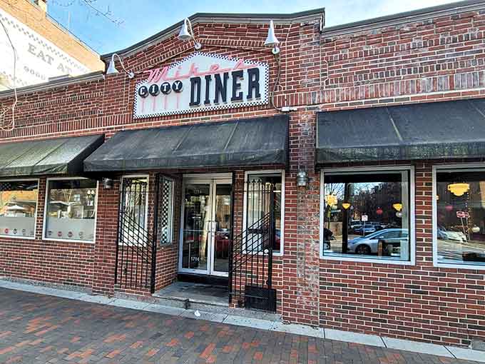 The iconic brick facade of Mike's City Diner stands proudly on Washington Street, its vintage neon sign a beacon for breakfast enthusiasts across Boston.