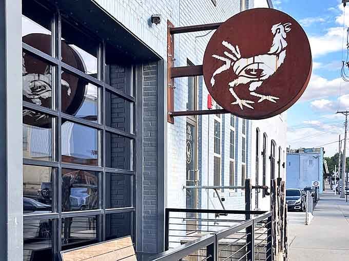 The Starving Rooster's iconic signage against pale blue brick perfectly captures the restaurant's blend of industrial charm and unpretentious character.
