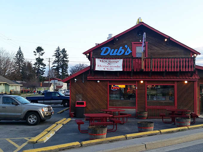 The rustic wooden exterior of Dub's Drive-In, with its signature red trim and picnic tables, stands as a time capsule of Americana in Sandpoint.
