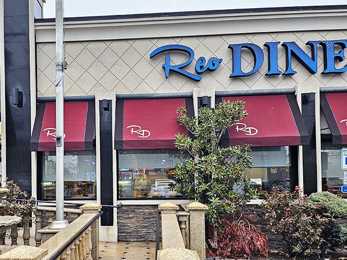 The iconic blue sign of Reo Diner stands as a beacon of comfort food in Woodbridge, promising pancakes that could double as frisbees and coffee that keeps flowing.