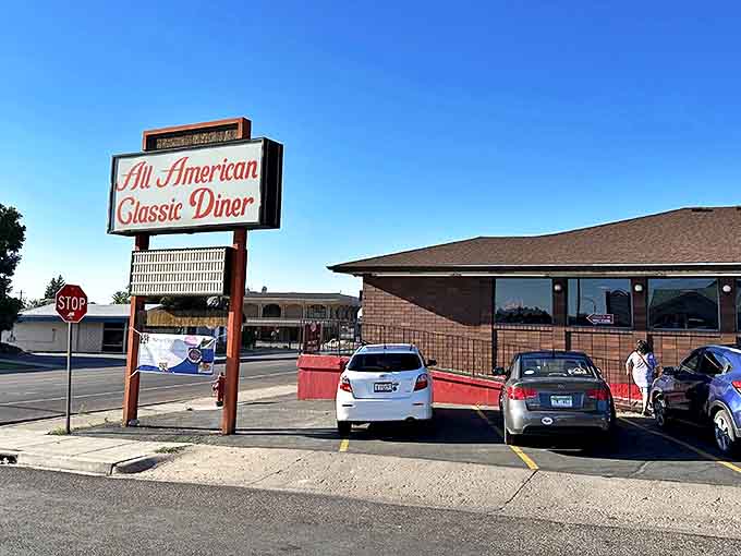 The iconic All American Classic Diner sign beckons hungry travelers like a lighthouse for the famished. Cedar City's culinary landmark stands ready to serve.