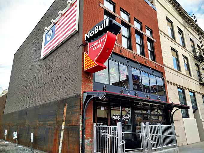 The American flag proudly displayed alongside NoBull's distinctive red arrow sign&mdash;patriotism and barbecue, two American traditions united.
