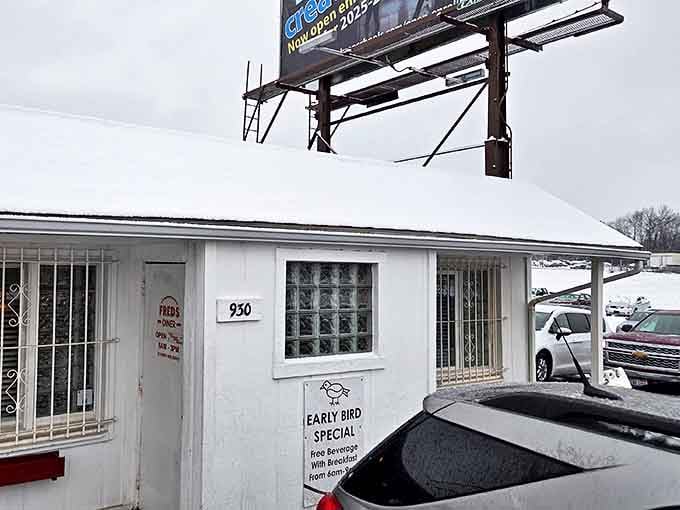 Even in winter, Fred's Early Bird Special sign beckons through the snow, promising warm refuge and hot coffee to start your day right.
