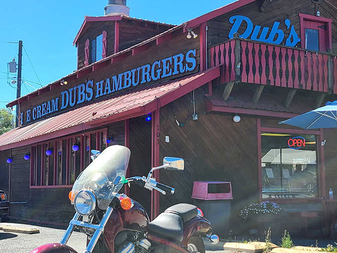 The rustic wooden exterior of Dub's Drive-In, with its signature red trim and picnic tables, stands as a time capsule of Americana in Sandpoint.