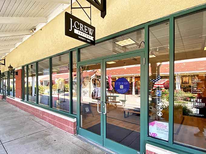 J.Crew's storefront beckons with promises of preppy perfection at prices that won't make your credit card weep. Window displays showcase seasonal styles while the clean lines invite bargain hunters inside.