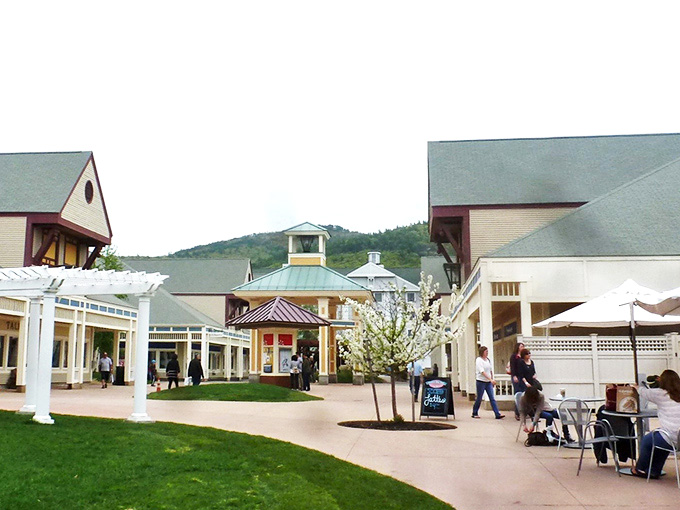 The village-style layout of North Conway's outlets transforms shopping into a scenic stroll, complete with gazebos, flowering trees, and mountain views.