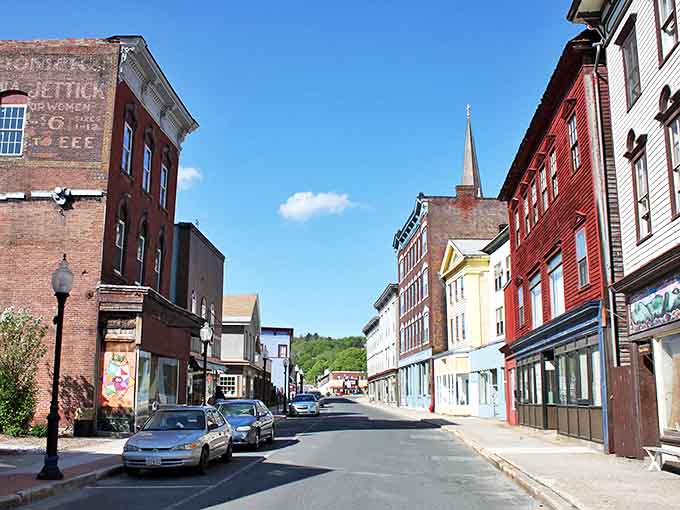 Downtown North Adams showcases classic New England charm with its historic brick buildings and church spires framed against rolling Berkshire hills.