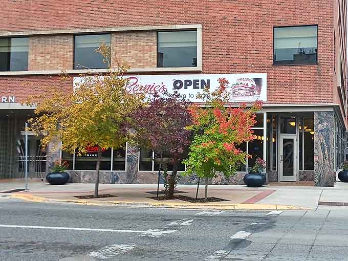 Colorful autumn trees frame Bernie's Diner, a brick-and-marble culinary landmark that's become a beloved fixture in Billings.
