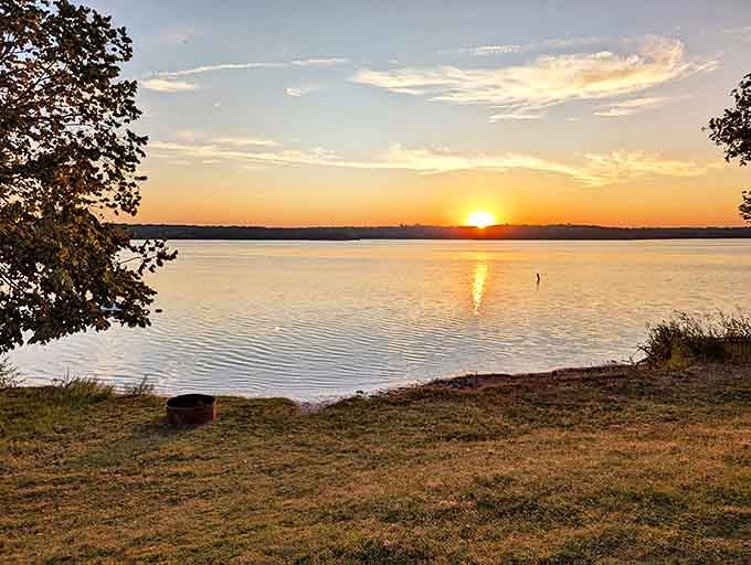 That magical moment when day surrenders to evening at Lake Thunderbird, painting the water in liquid gold that would make King Midas jealous.