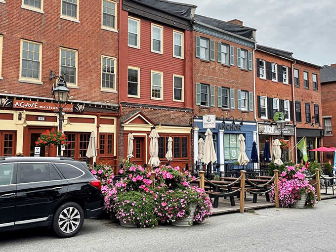 Colorful storefronts and outdoor dining spaces invite visitors to linger along Newburyport's charming streets, where historic architecture meets modern vitality.