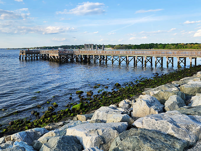The fishing pier stretches into Narragansett Bay like nature's red carpet, inviting you to stroll above the waters where memories are made and fish stories are born.