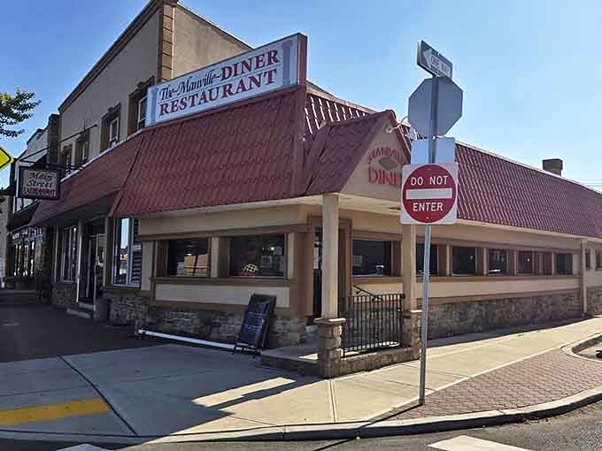 The iconic red roof of Manville Diner beckons hungry travelers like a lighthouse guiding ships to safe harbor. Classic Jersey diner architecture at its finest.