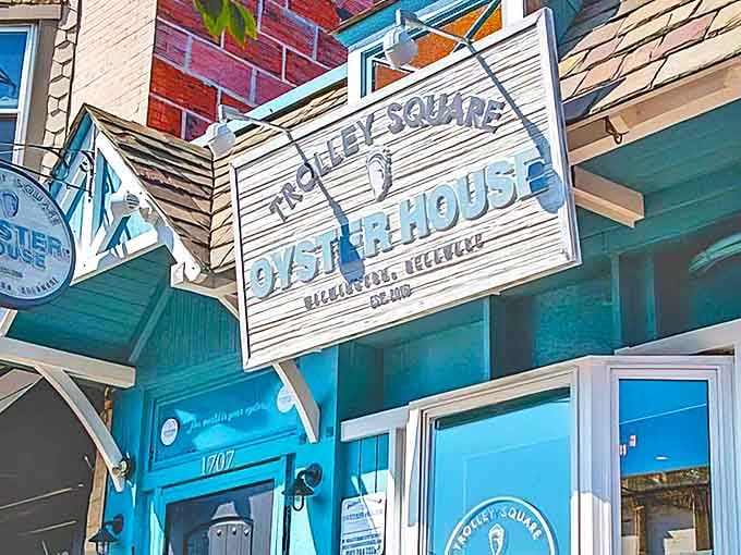 The weathered blue exterior and vintage signage of Trolley Square Oyster House beckons seafood lovers like a lighthouse calling ships home.
