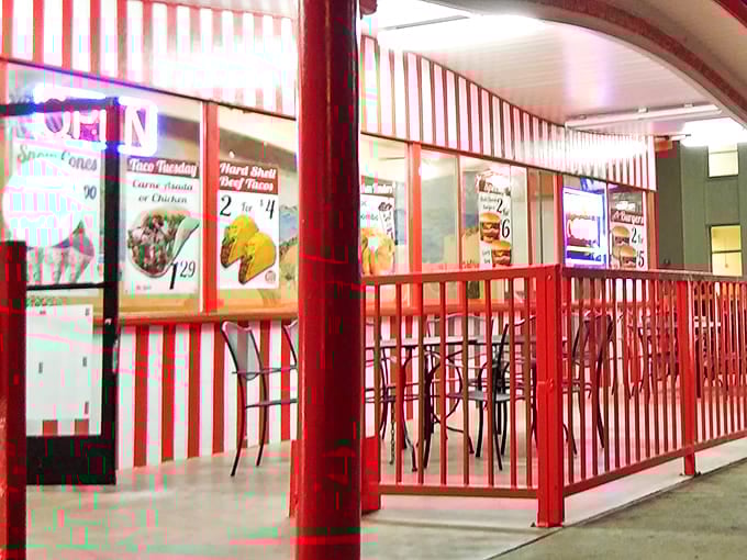 The covered patio area with its distinctive red railings offers the quintessential California burger joint experience &ndash; casual dining with a side of people-watching.