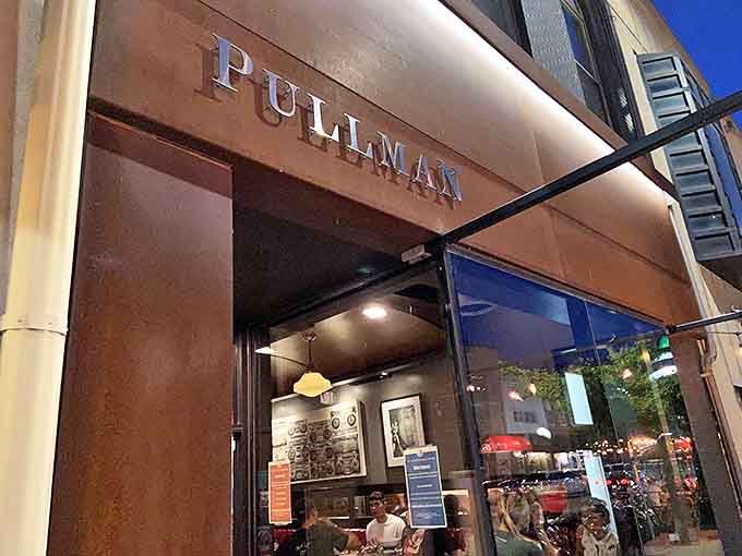 The rusty-hued exterior of Pullman beckons like a time machine to railway elegance, standing proudly among Iowa City's historic downtown buildings.